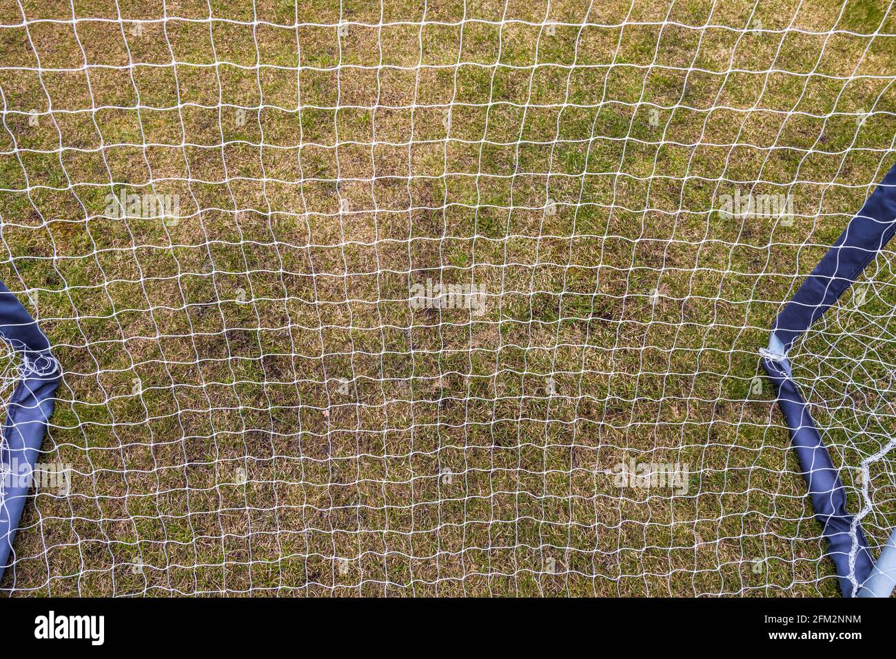 Close up texture background view of goal net on grass field background ...