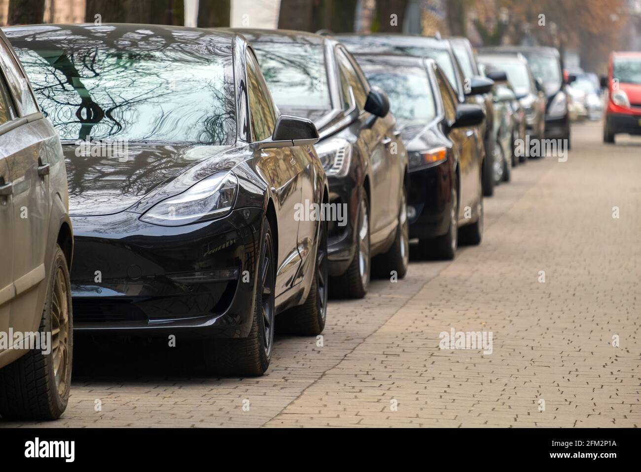 Cars parked in a row on a city street side Stock Photo - Alamy