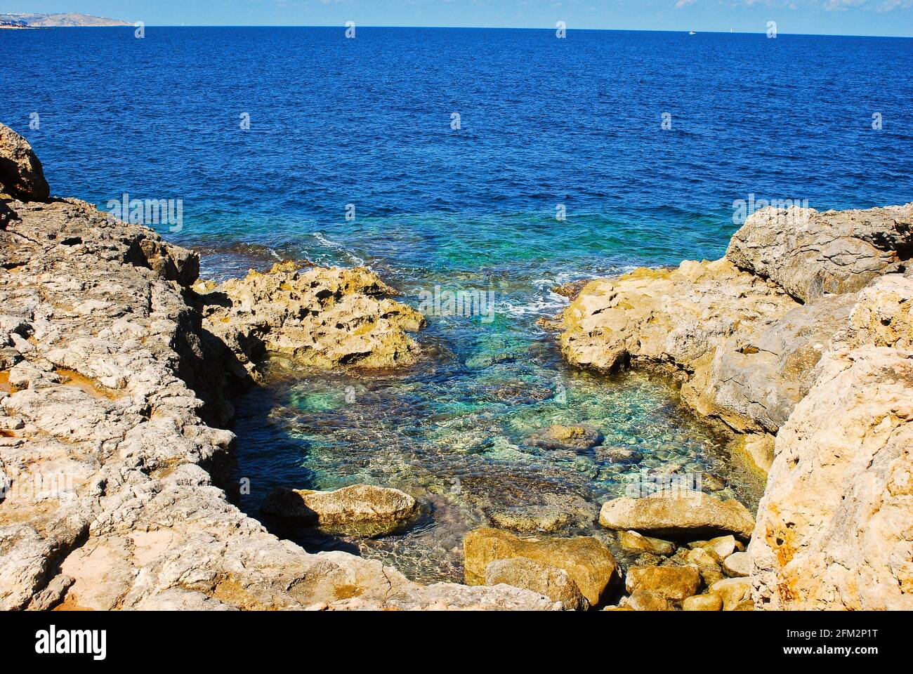 Qawra Point basin in the rocky coast of Malta island near Sea Aquarium ...