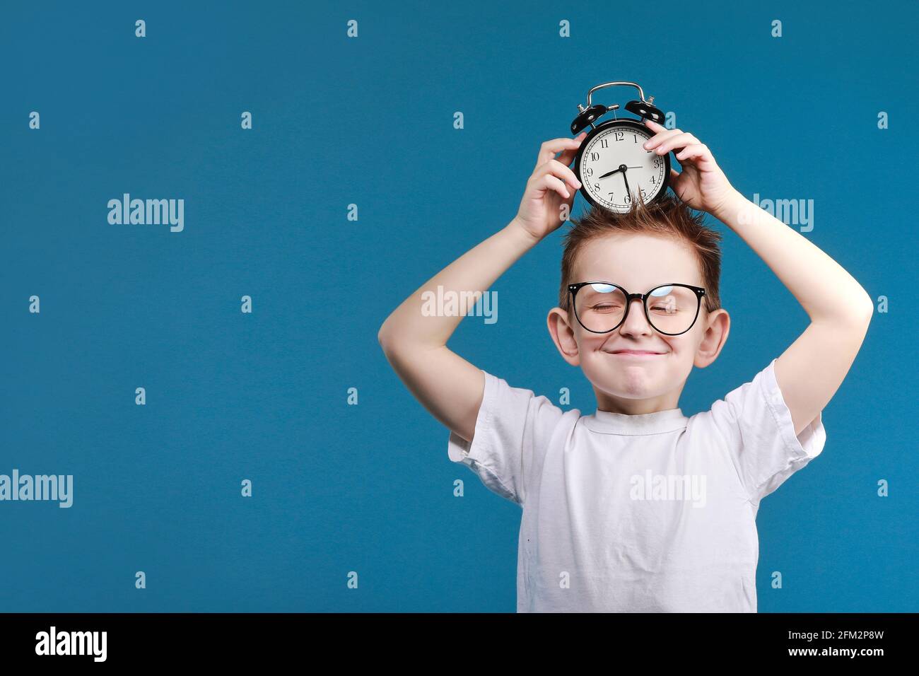 Time management. Morning. little boy with alarm clock. Happy childhood ...