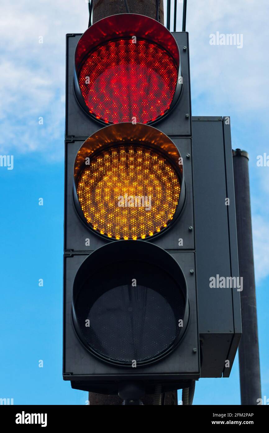 Modern LED traffic light with two light indications yellow and red ...