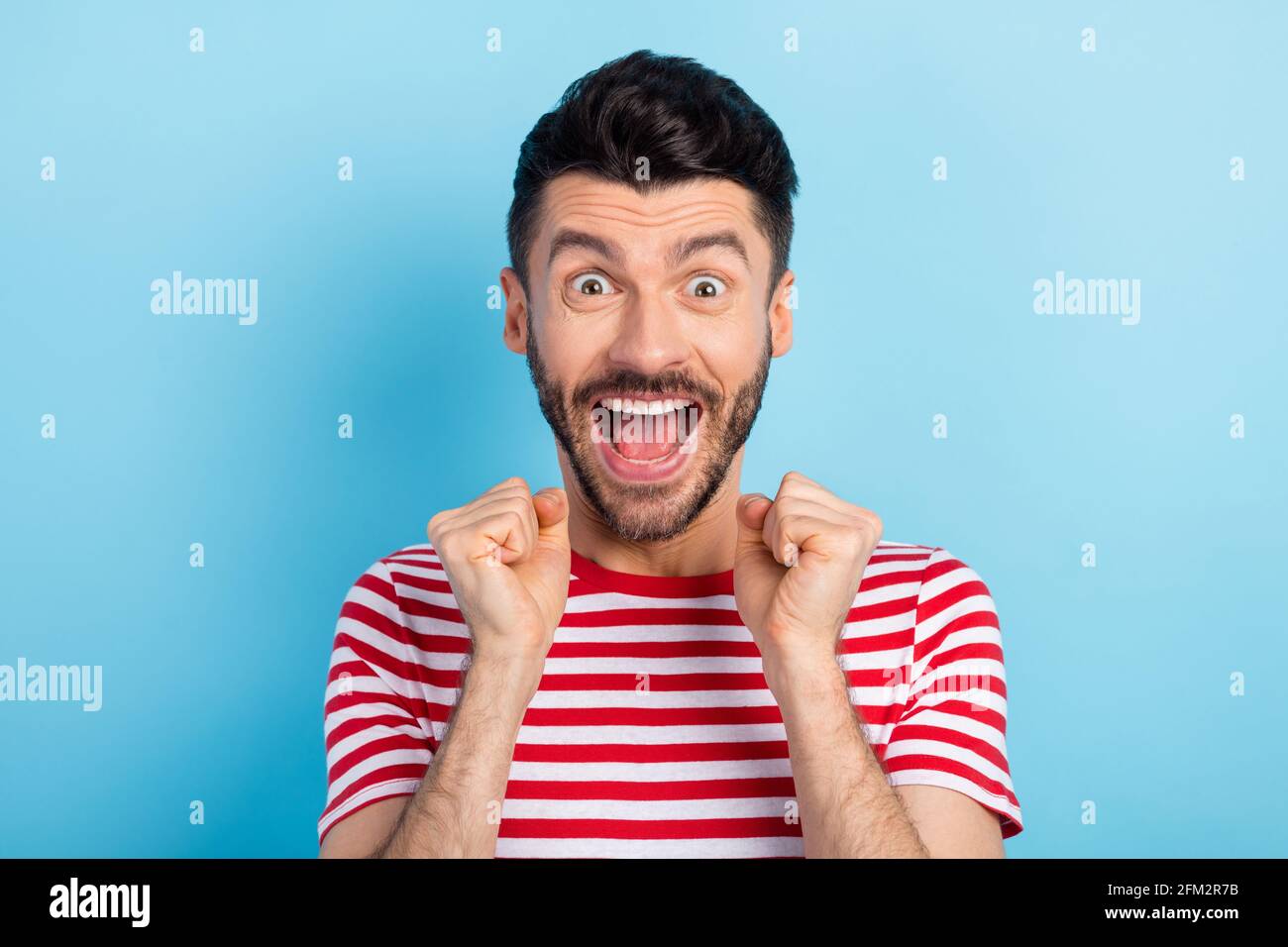 Photo of crazy happy cheerful young man winner celebrate lottery luck ...