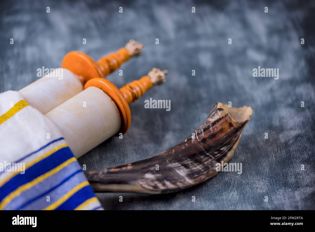 Prayer shawl in the shofar horn on soft focus Jewish torah scroll Stock ...