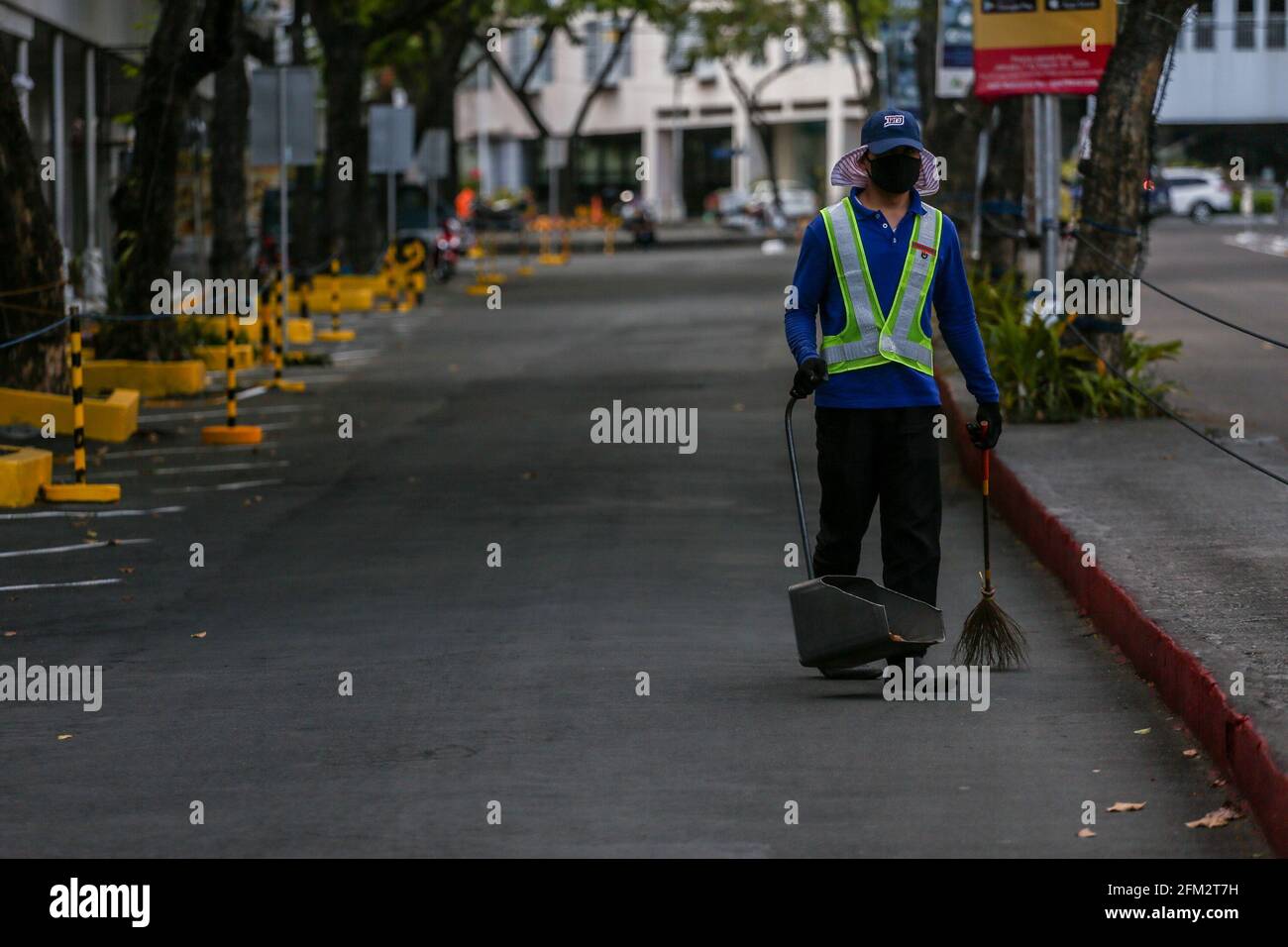 A janitor sweeps in front of an empty bus terminal during the ...