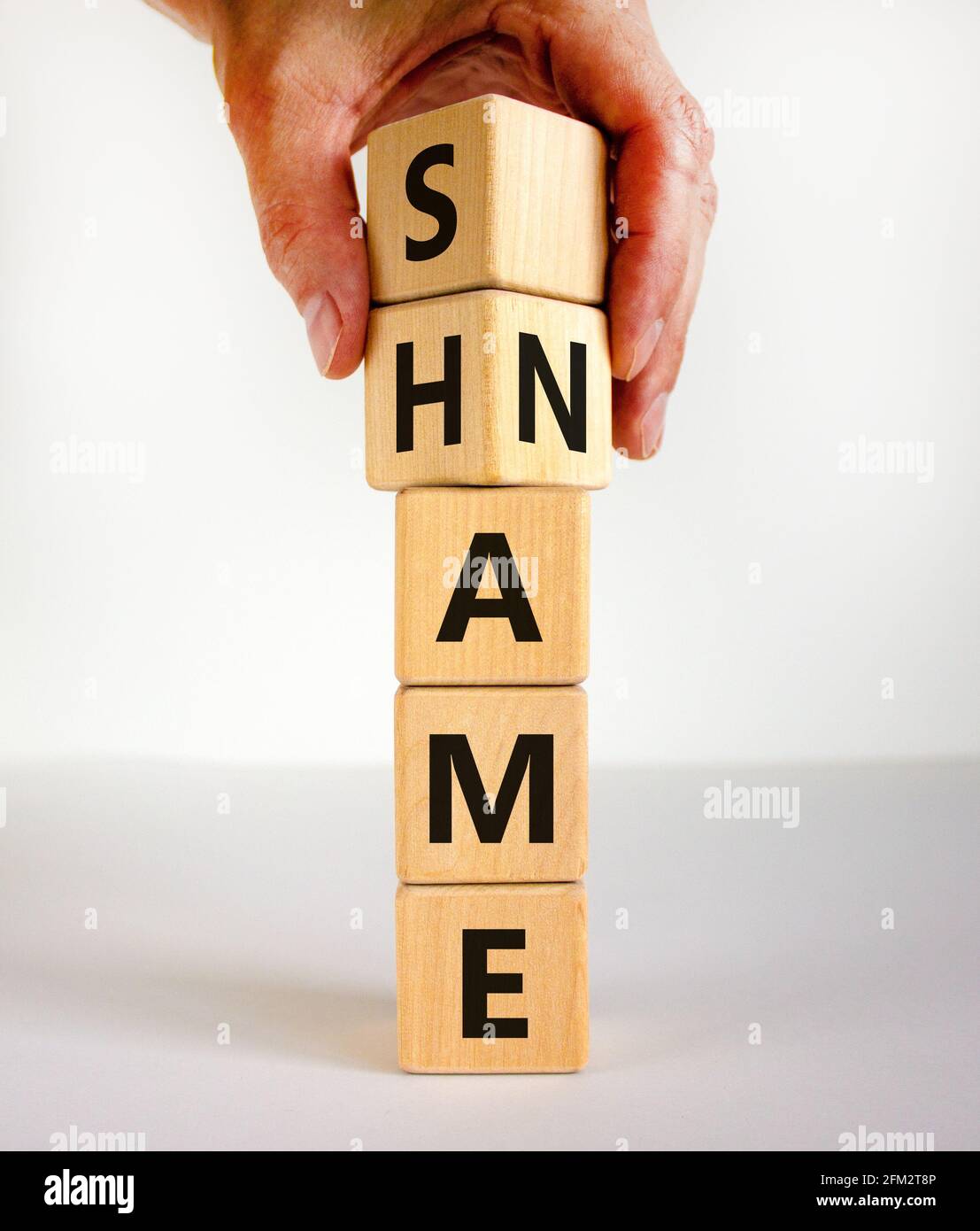 Name or shame symbol. Businessman turns wooden cubes and changes the ...