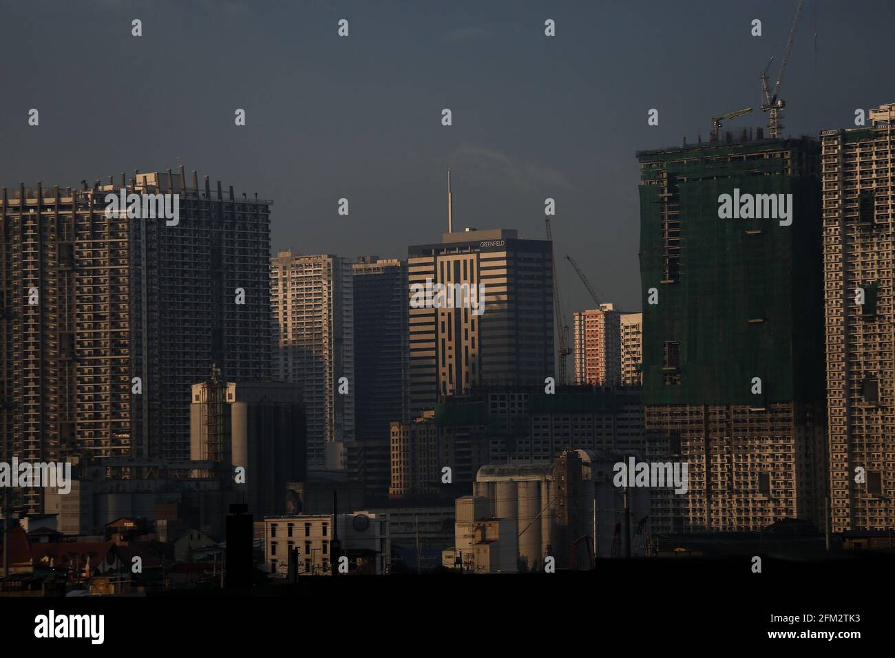 Buildings in Metro Manila are seen at dusk during a coronavirus ...