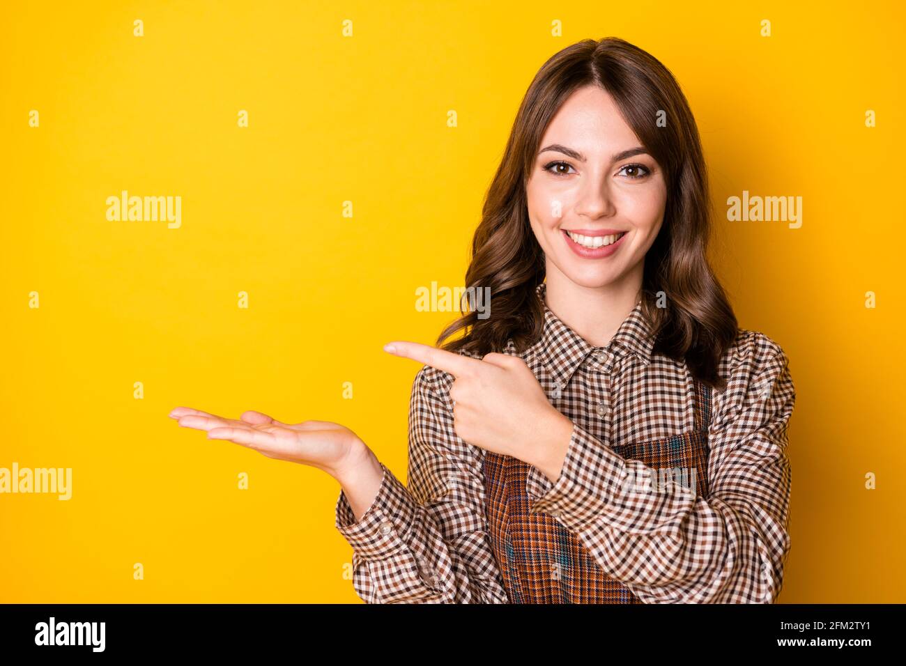 Portrait of positive charming lady indicate finger empty space hand ...