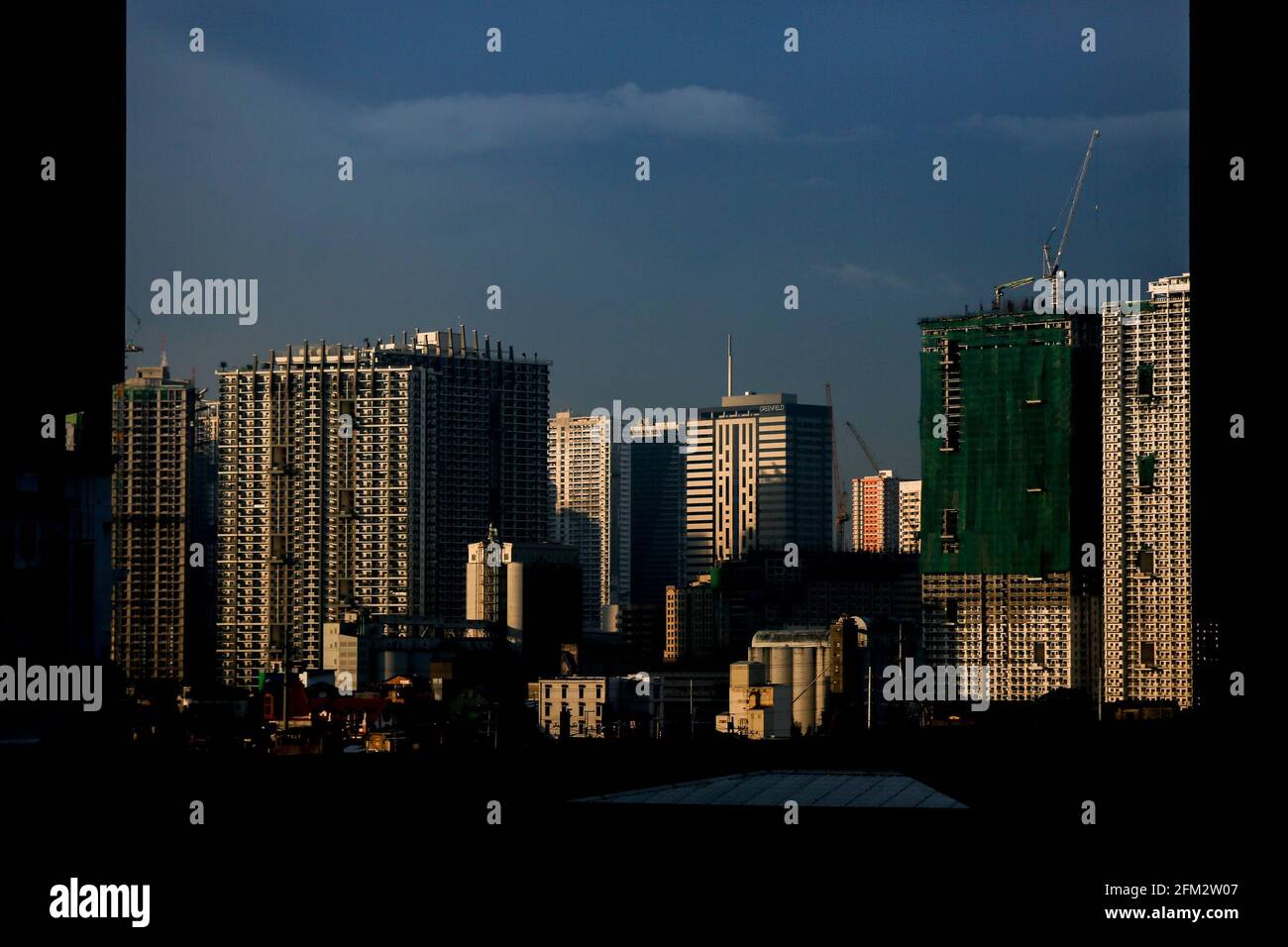 Buildings in Metro Manila are seen at dusk during a coronavirus ...