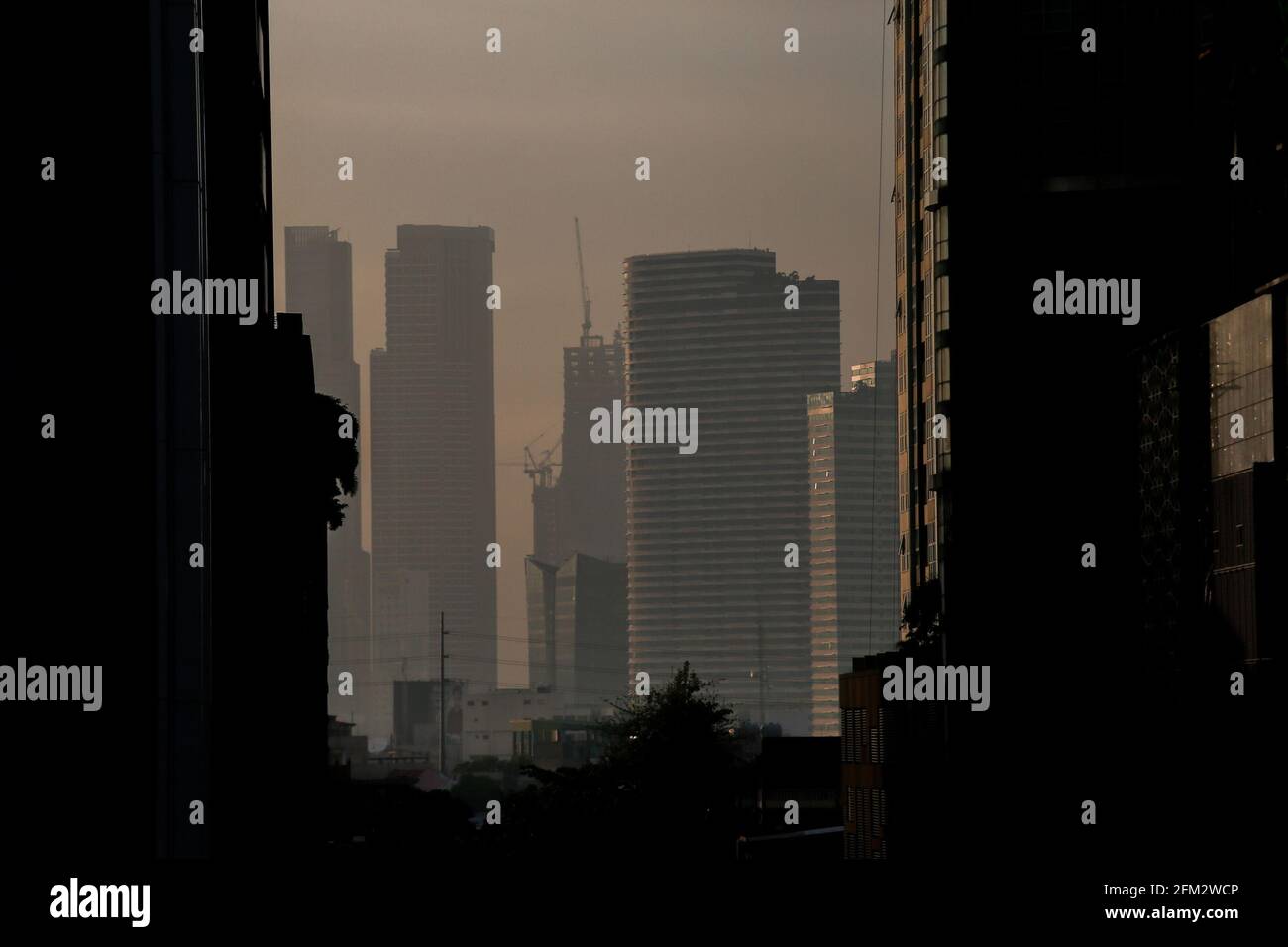 Buildings in Metro Manila are seen at dusk during a coronavirus ...