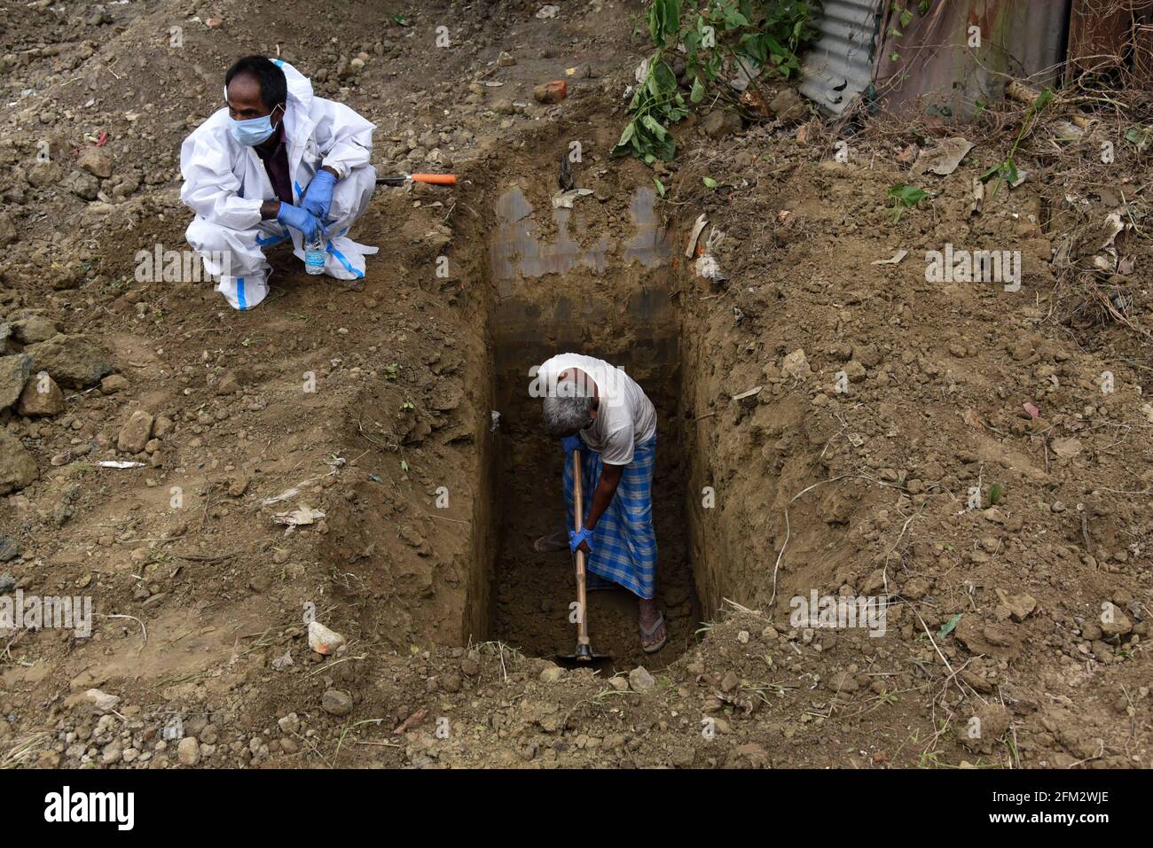 May 3, 2021: Municipal workers digging to bury a body of a person who ...