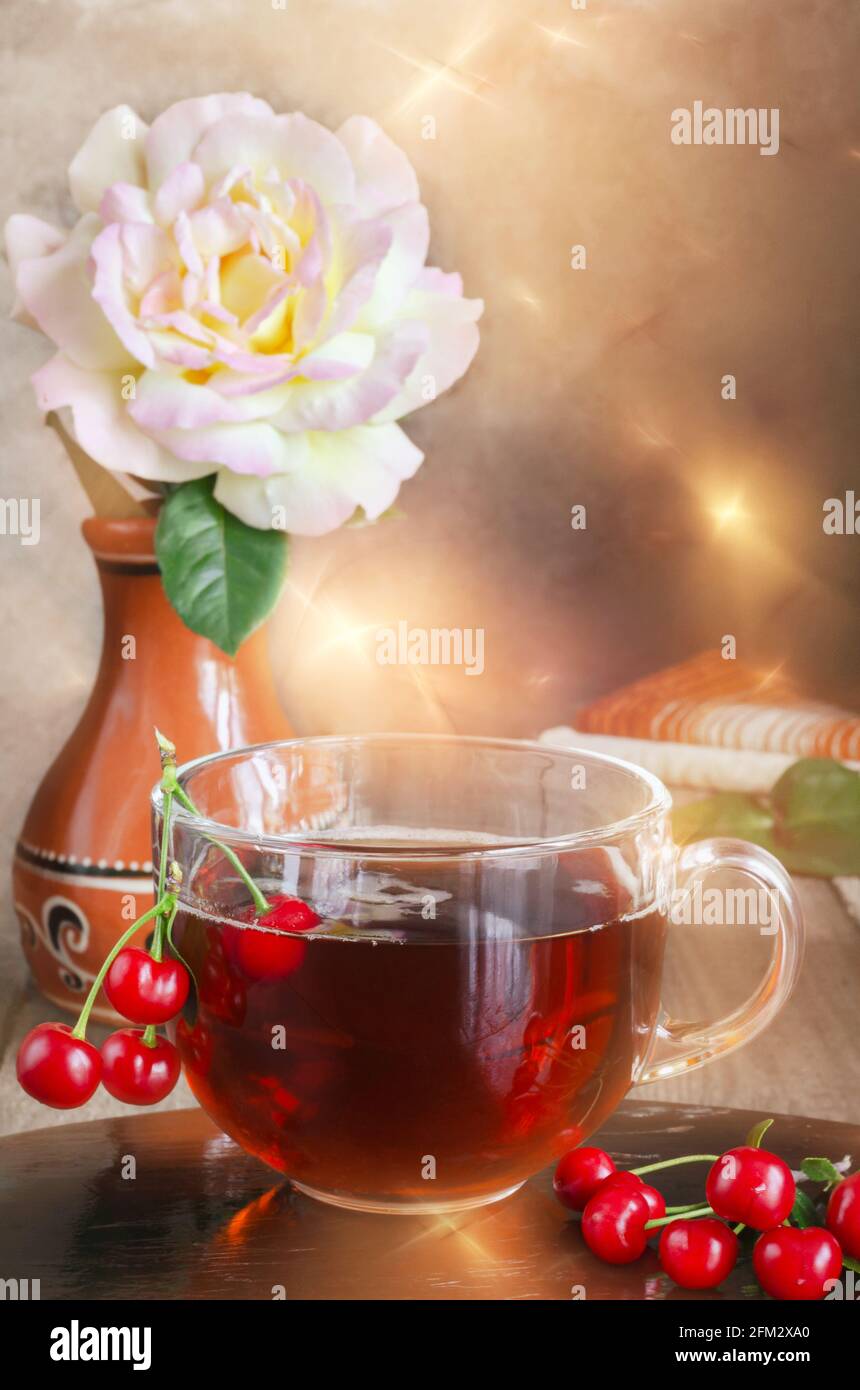 Fresh fruit cherry drink in a clear glass cup, and cherry berries on a ...