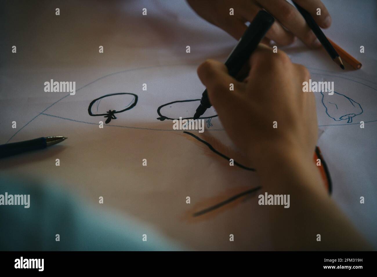 Person drawing with markers on a paper Stock Photo - Alamy