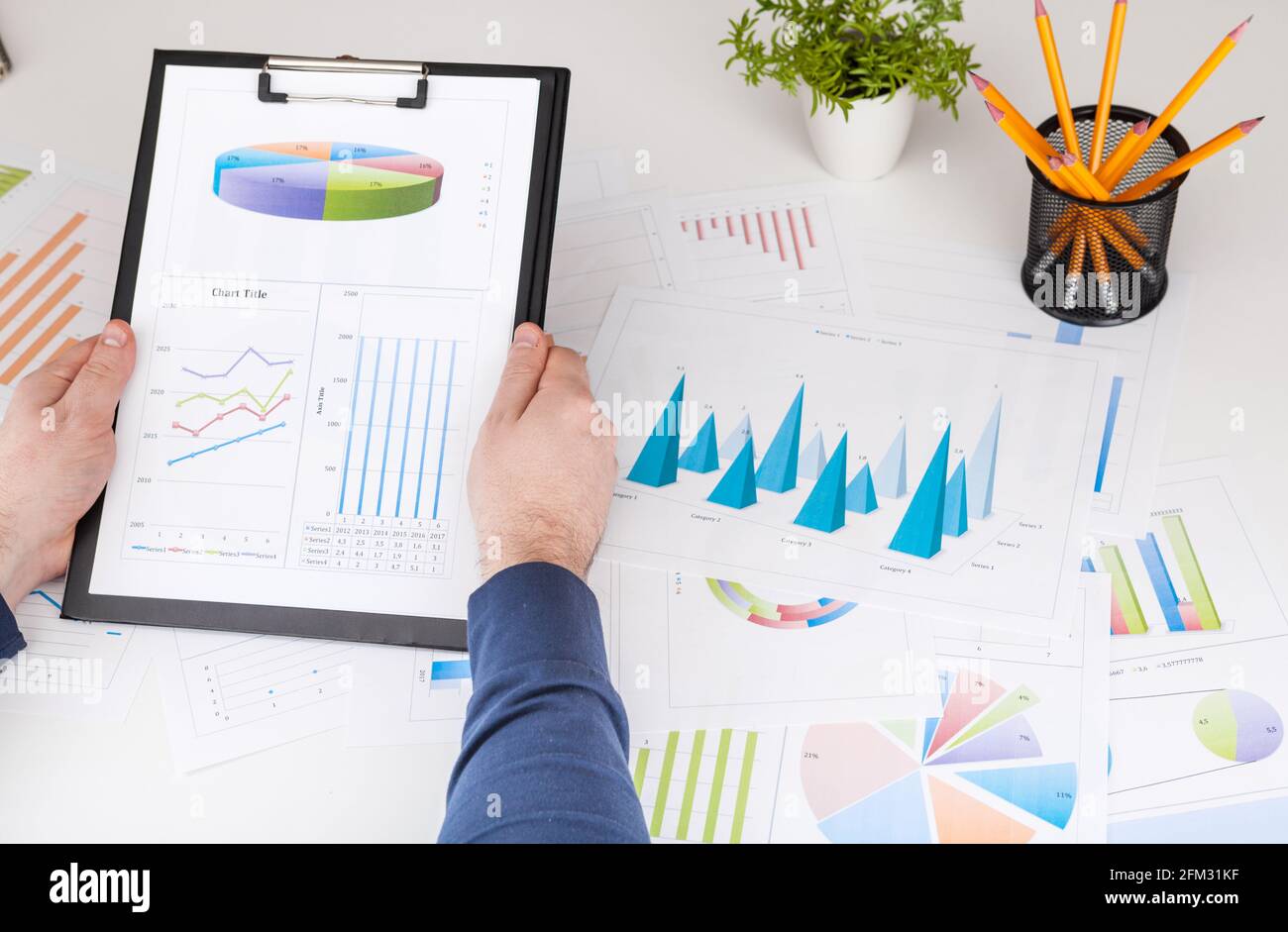 Closeup of a man checking accounts. Stock market chart and finger ...