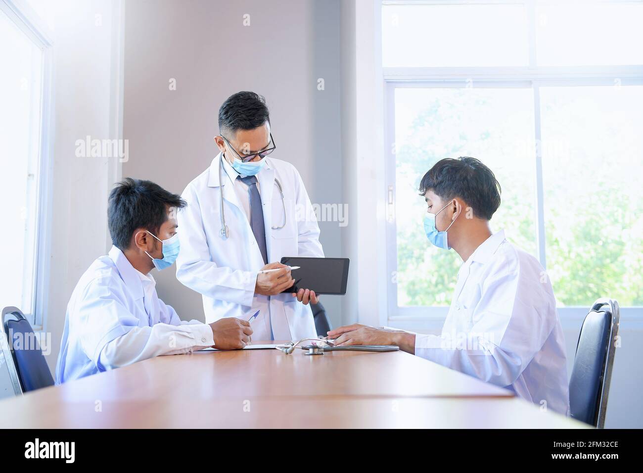 Young doctor brainstorming sitting in hi-res stock photography and ...