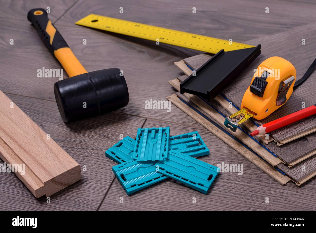 Planks of laminate floor and equipment or tools to install them, rubber ...