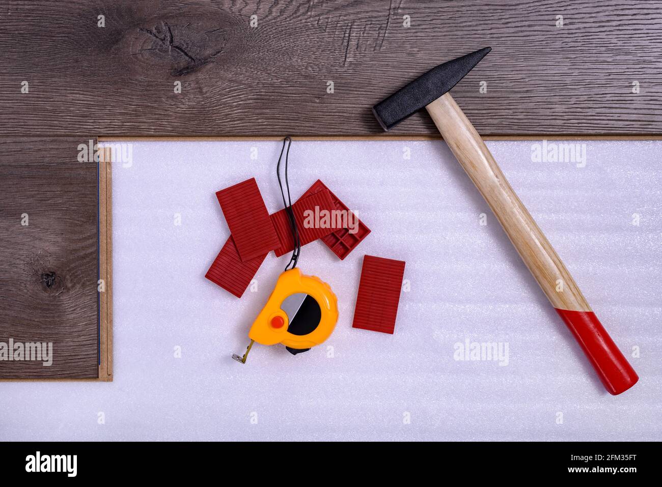 Equipment or tools to install laminate floor. Hammer, spacers and tape ...
