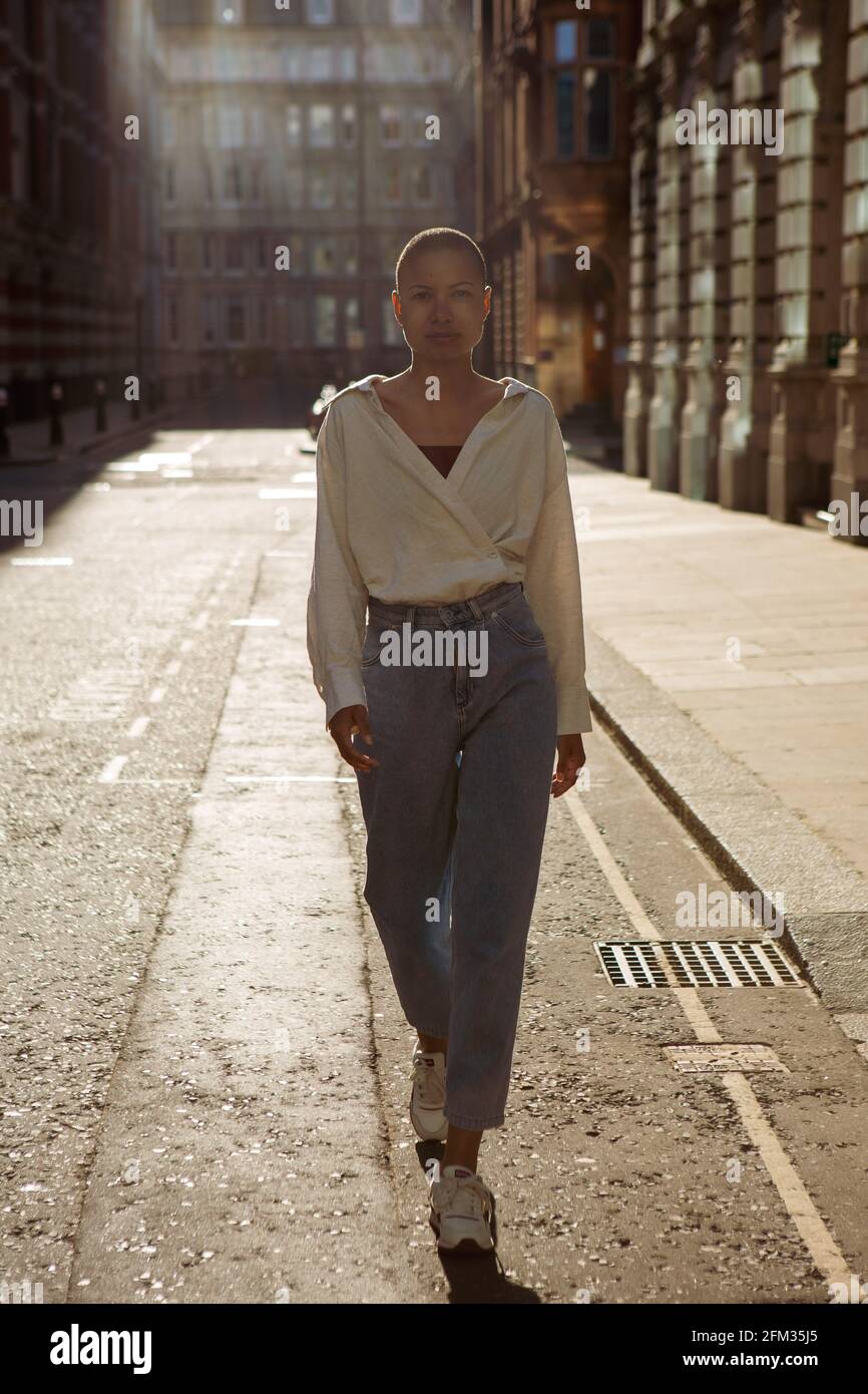 A model wearing a white shirt and Jeans, Reebok trainers during a ...