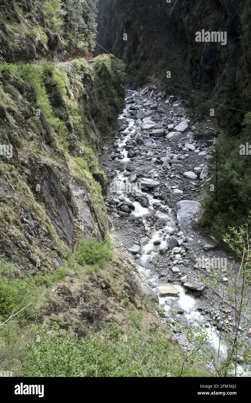 Vertical shot of a thin current of water at the source in Yamuna River ...