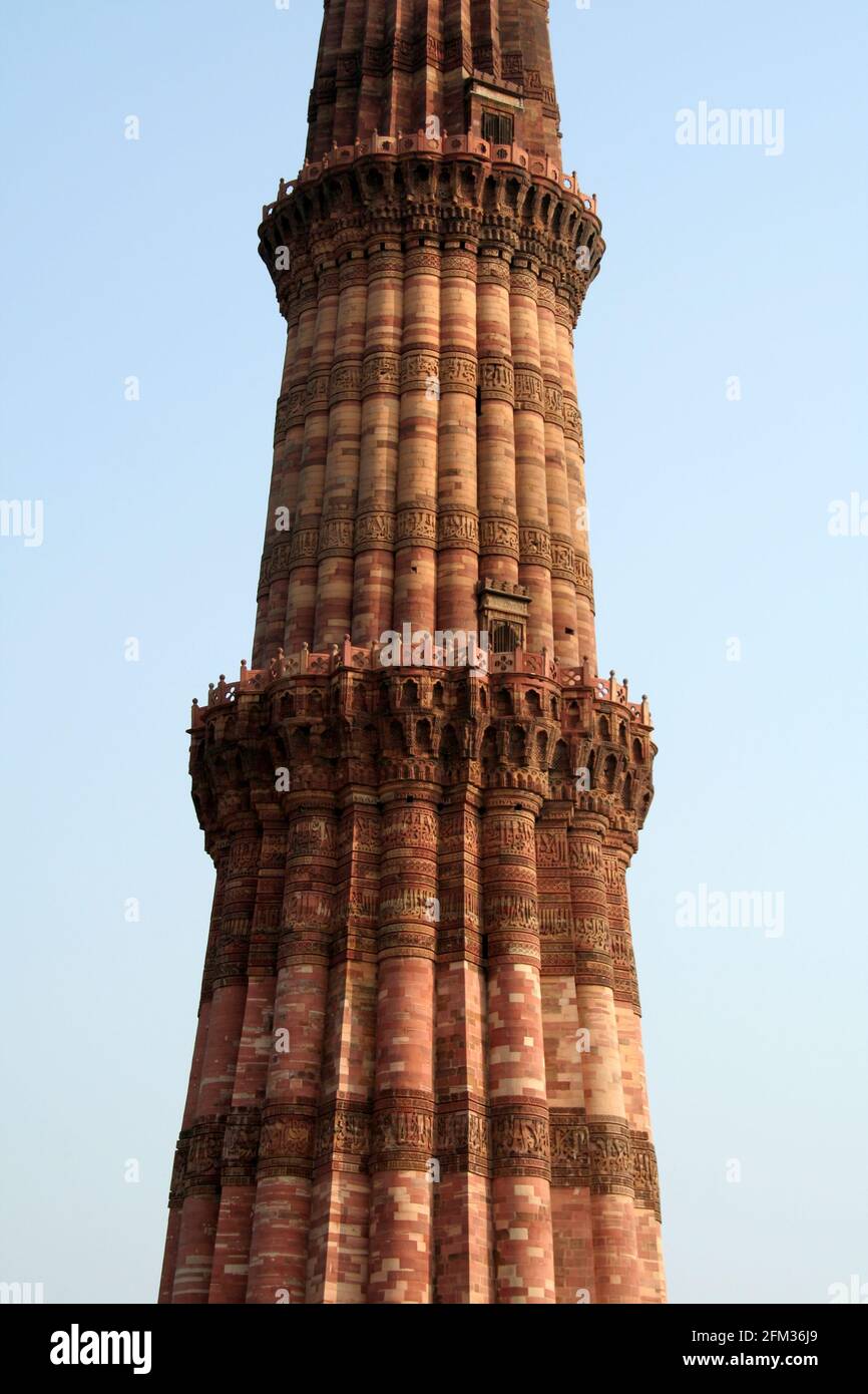 Vertical shot of the exterior design and stone balconies of Qutub Minar ...