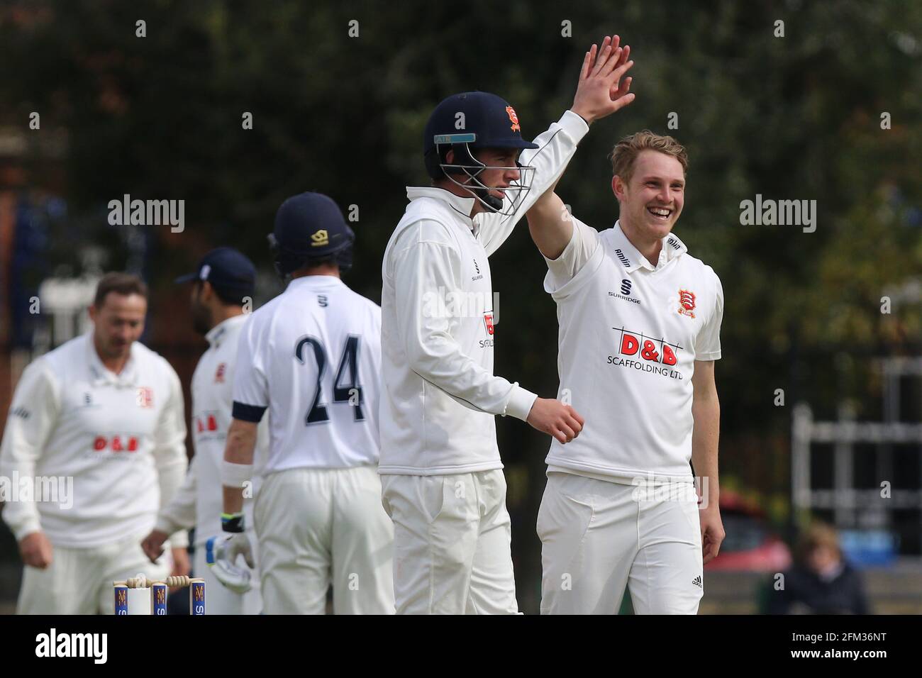 Jamie Porter of Essex (R) celebrates taking the wicket of Ben Bryant ...
