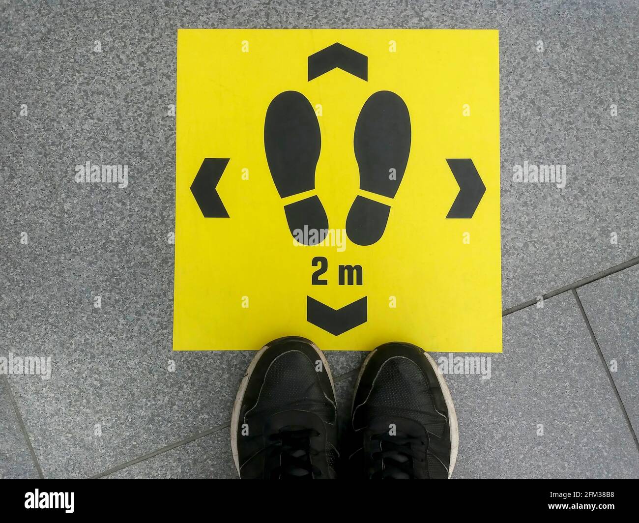 Keep distance sign printed on the floor, safety sticker on ground ...