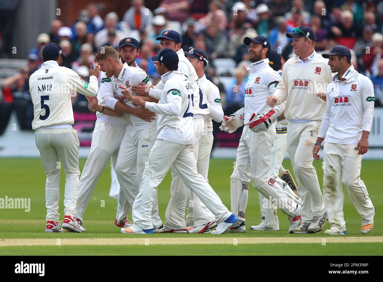Jamie Porter of Essex is congratulated by his team mates after taking ...