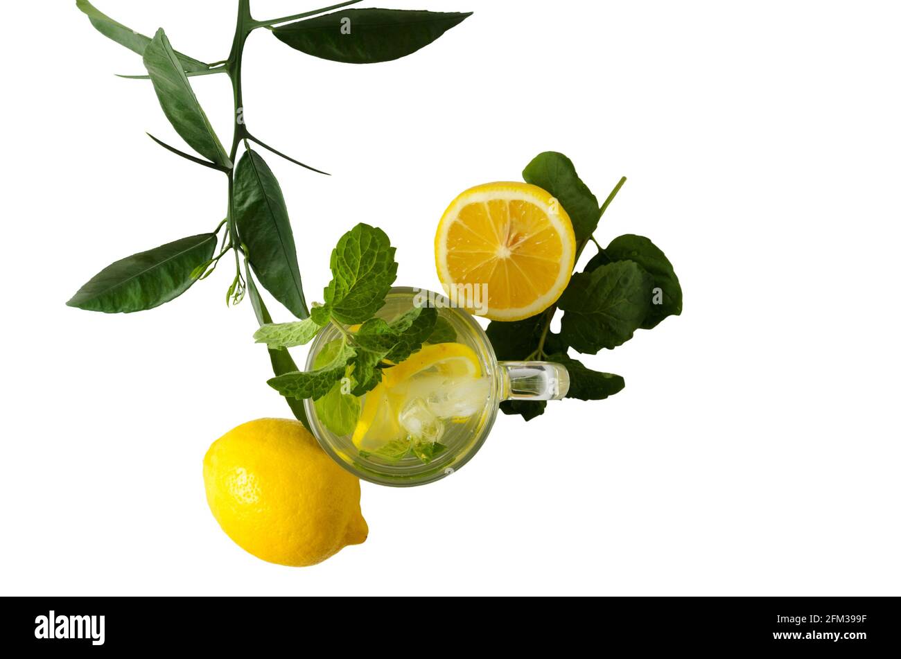 A glass glass of lemonade. Water with lemon slices, mint leaves and ice ...