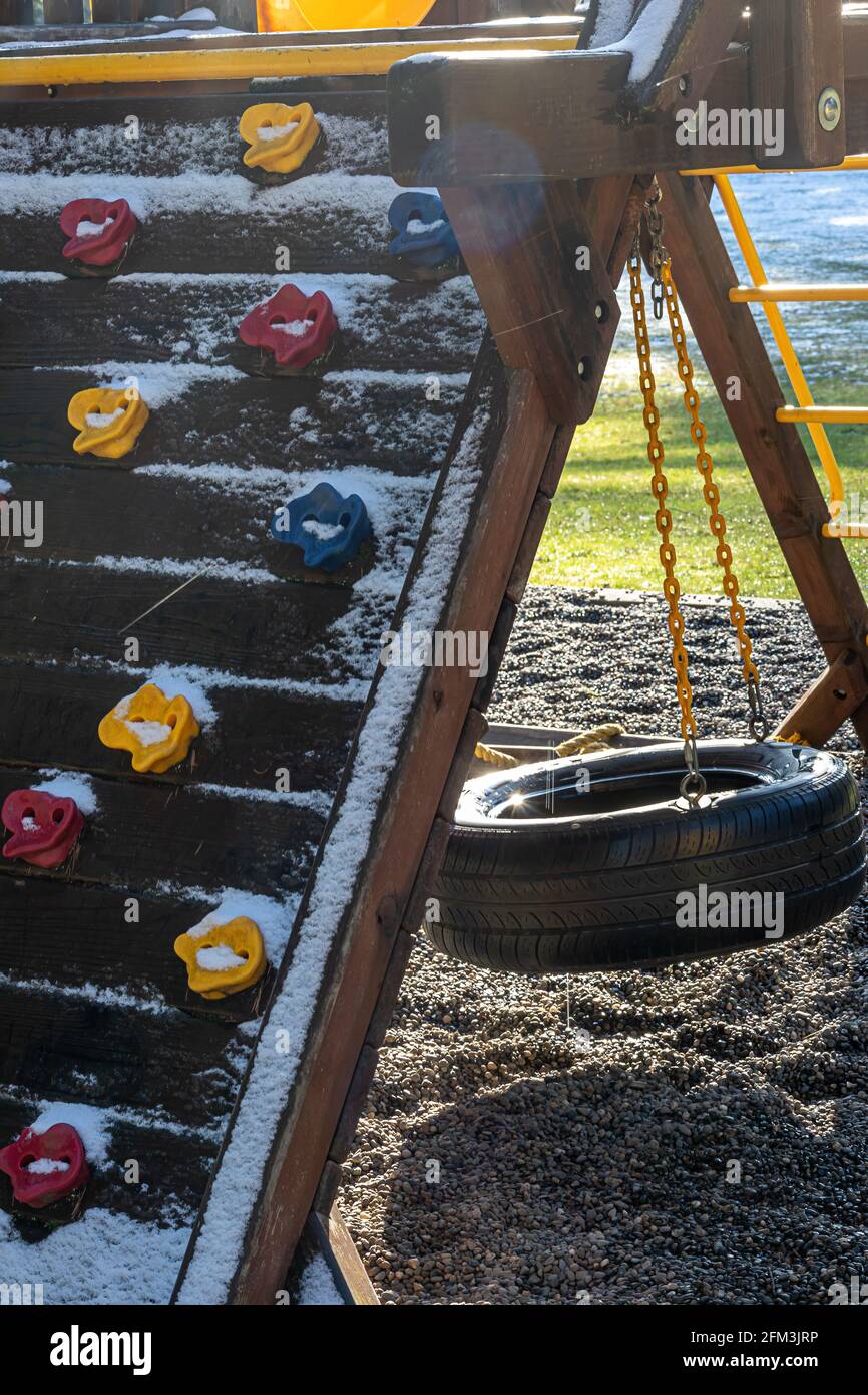 play area with tire swink in snow and winter weather Stock Photo - Alamy