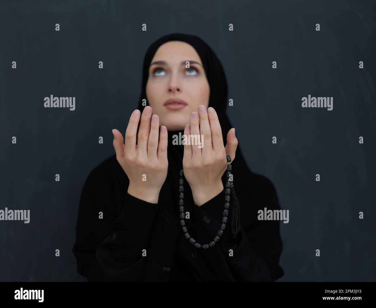 Portrait of young Muslim woman making dua Stock Photo - Alamy