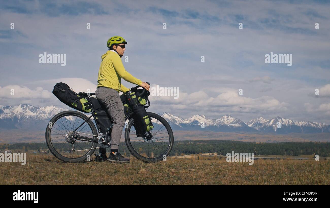 The man travel on mixed terrain cycle touring with bikepacking. The ...