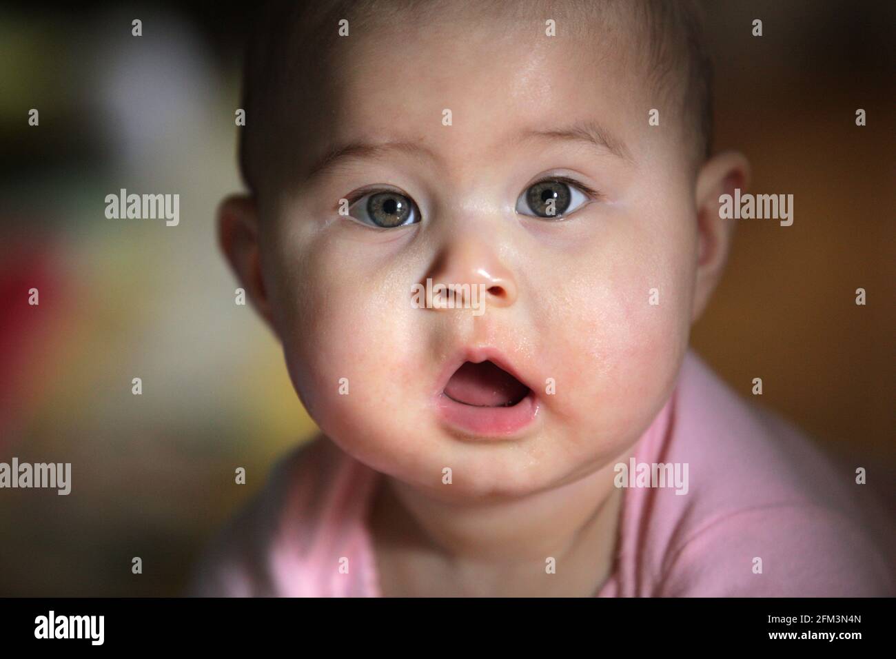 Baby looking at us with amazement Stock Photo - Alamy