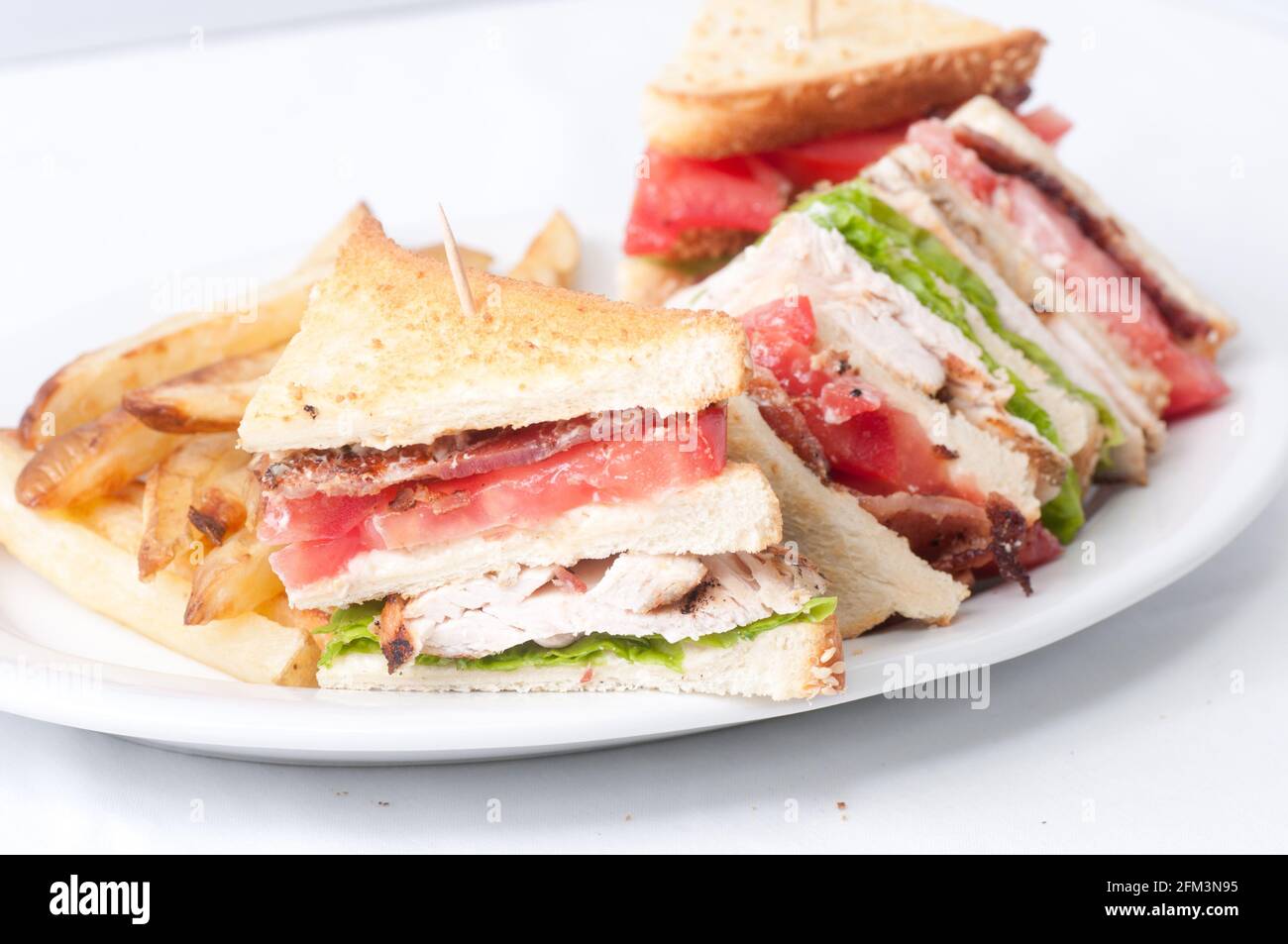 clubhouse sandwich with crispy fries Stock Photo - Alamy