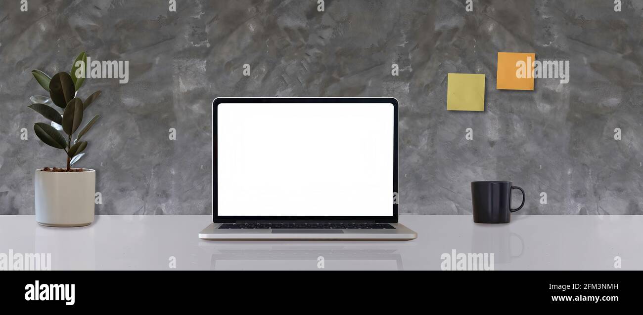 Mock up laptop computer with blank white screen of placed on office ...