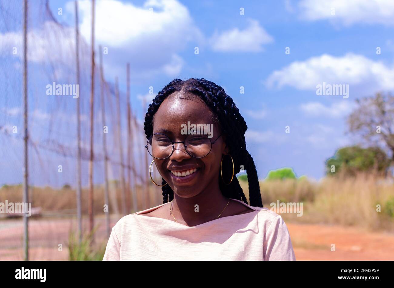 Young Nigerian female student with glasses looking at the camera ...