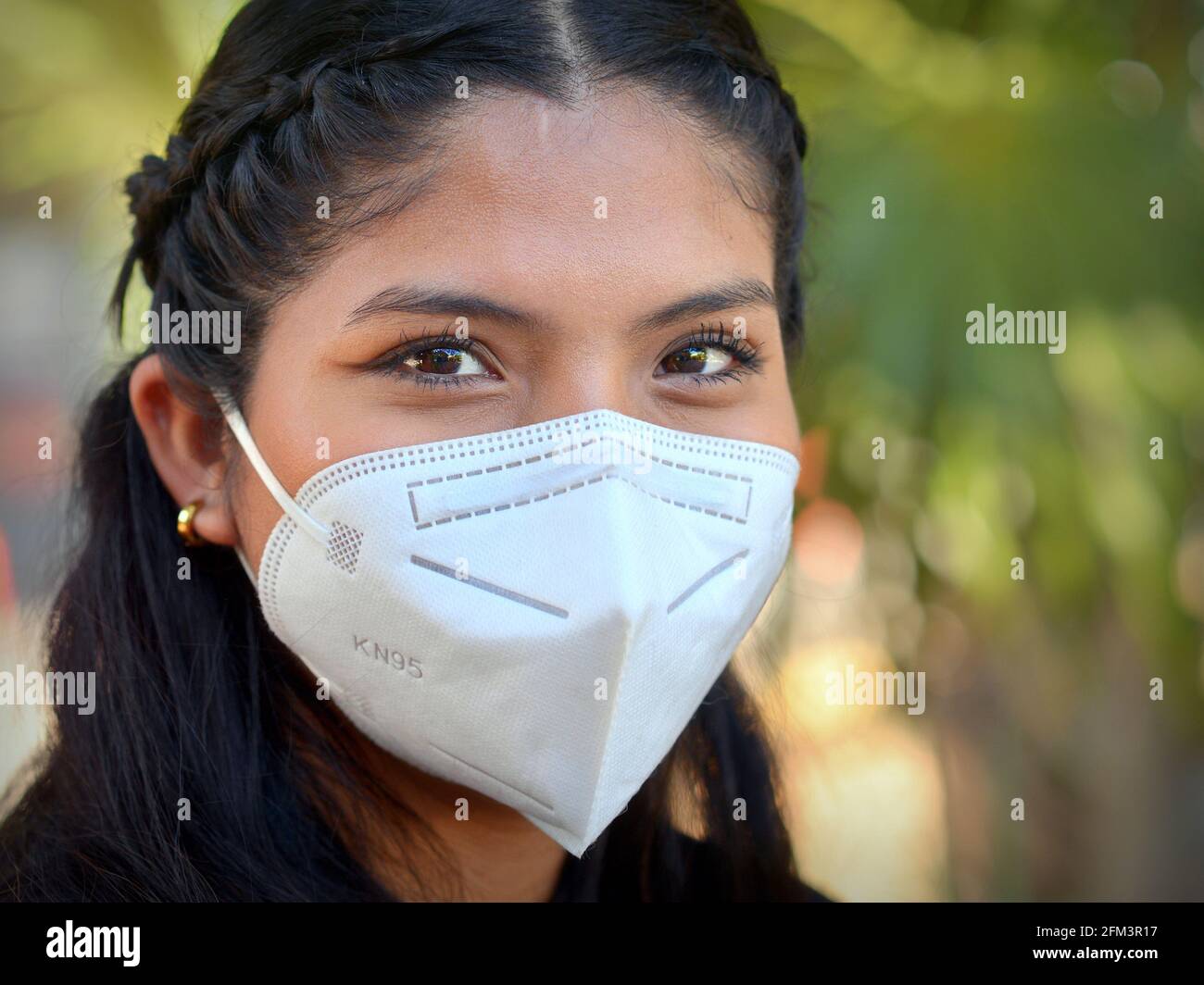 Young positive Mexican latina woman with beautiful brown eyes wears a ...