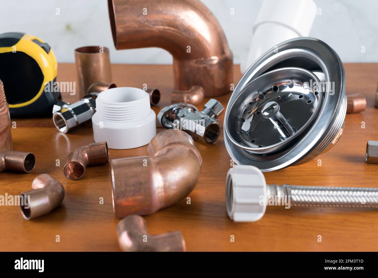 Different Plumbers tools and fittings on wood background. Selective ...