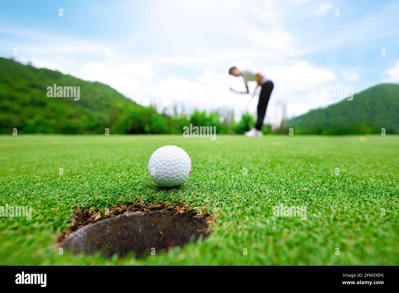 Man putting golf ball on the green golf.,close up in golf coures Stock ...