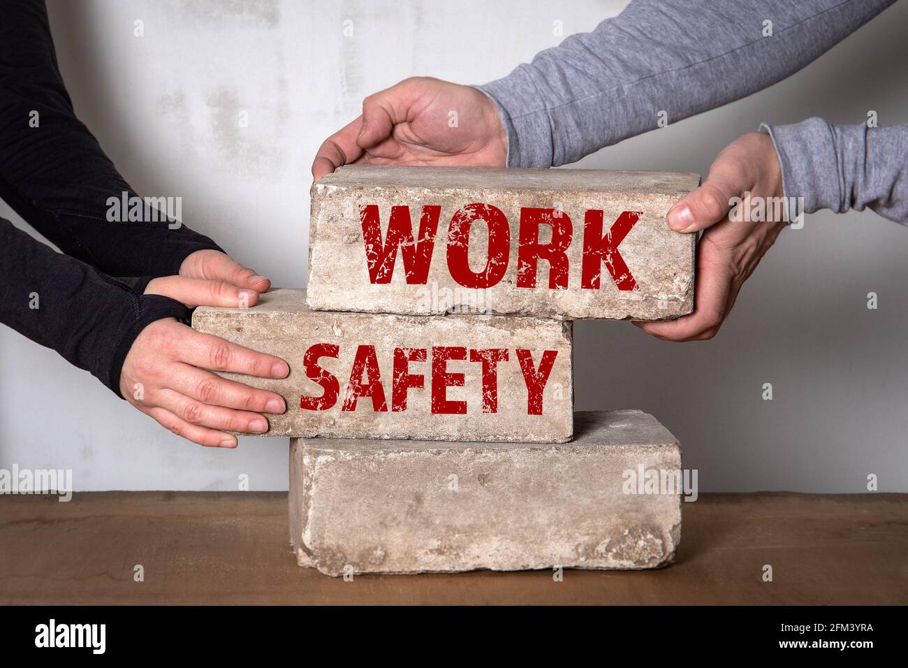 WORK SAFETY concept. Man and woman building a brick pile Stock Photo ...