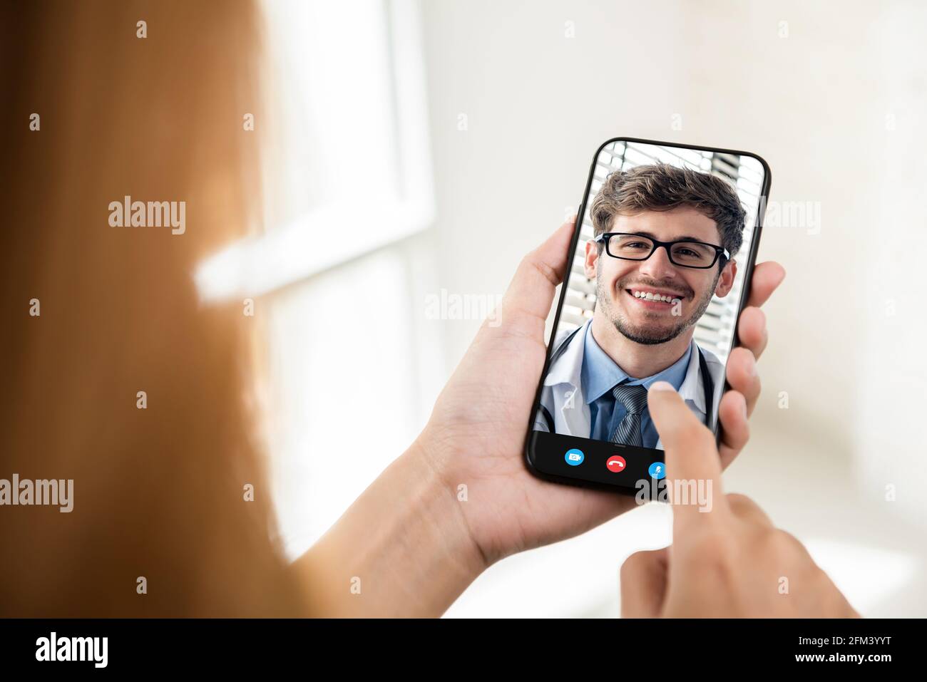 Woman patient making video call with doctor online via smartphone, home ...