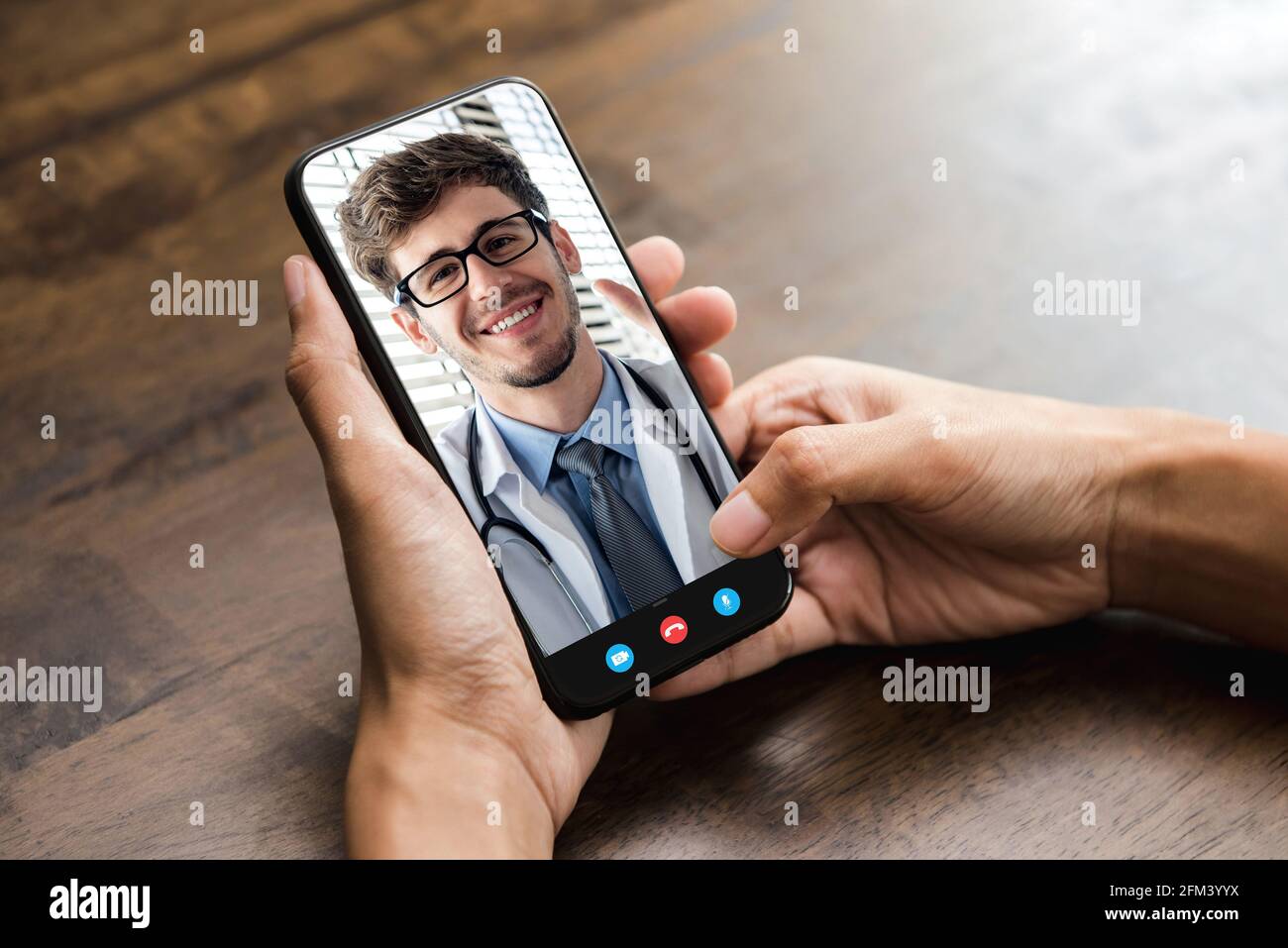 Patient making video call with doctor online via smartphone, home ...