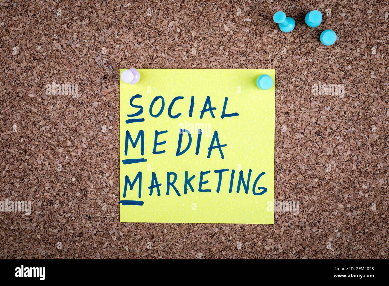 Social Media Marketing. Text on a sticky note pinned to a corkboard ...