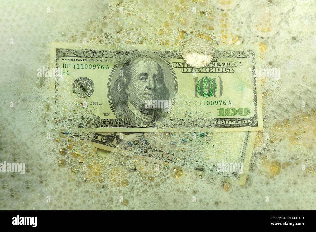 Money laundering concept, dollars in soapy water. Laundering of ...
