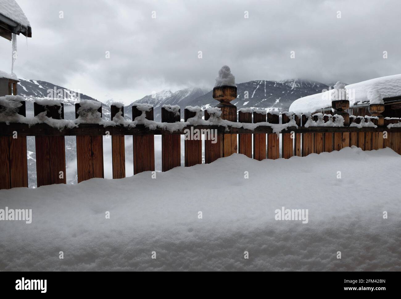 view on big heap of fresh snow covered a wooden terrace in alpine ...