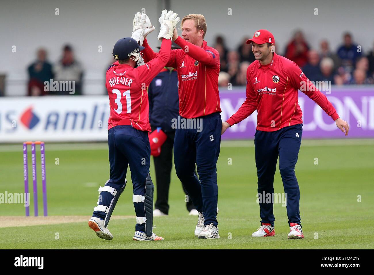 Simon Harmer of Essex (C) celebrates taking the wicket of Michael ...