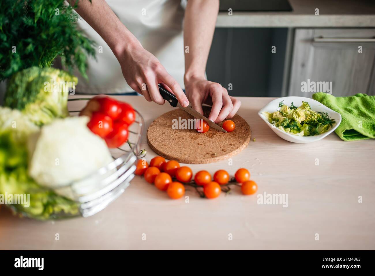 male hands chopping salad and onion, cooking healthy food in the ...