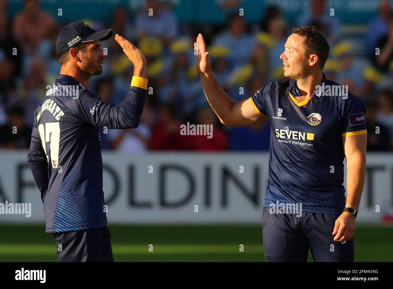Graham Napier (R) of Essex celebrates taking the wicket of Lewis ...