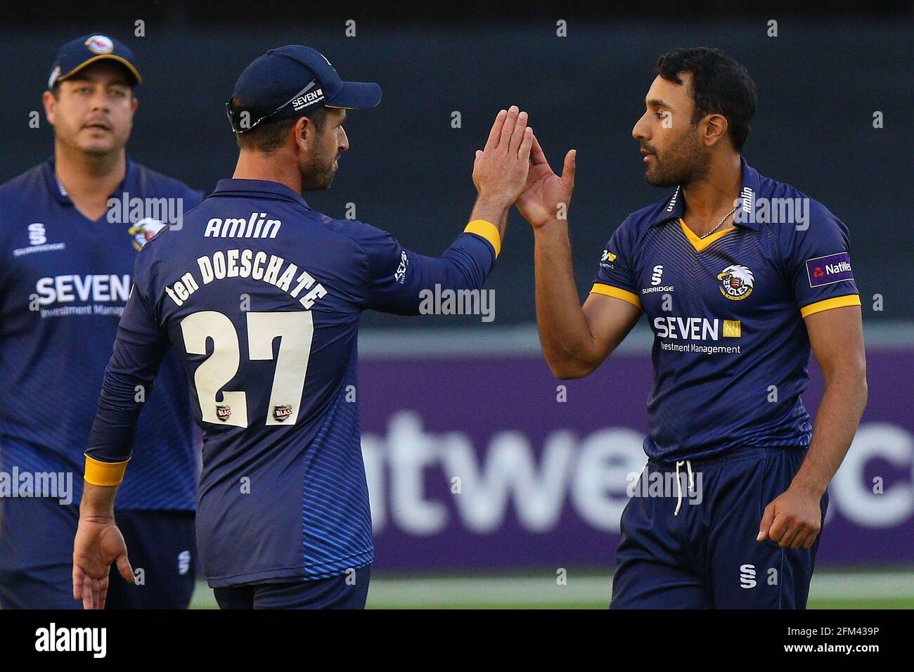Ravi Bopara (R) of Essex celebrates taking the wicket of Liam Dawson ...