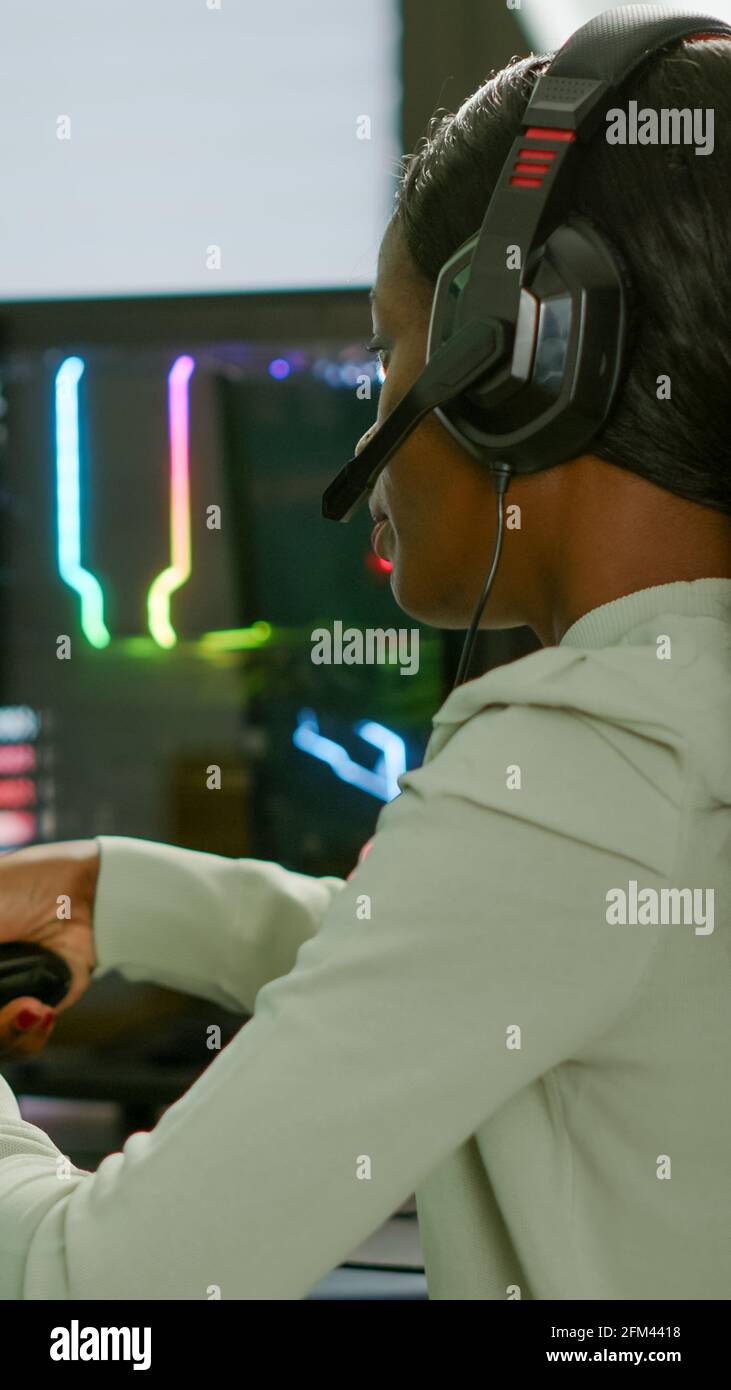 Pro african gamer playing online space shooter game on powerful ...