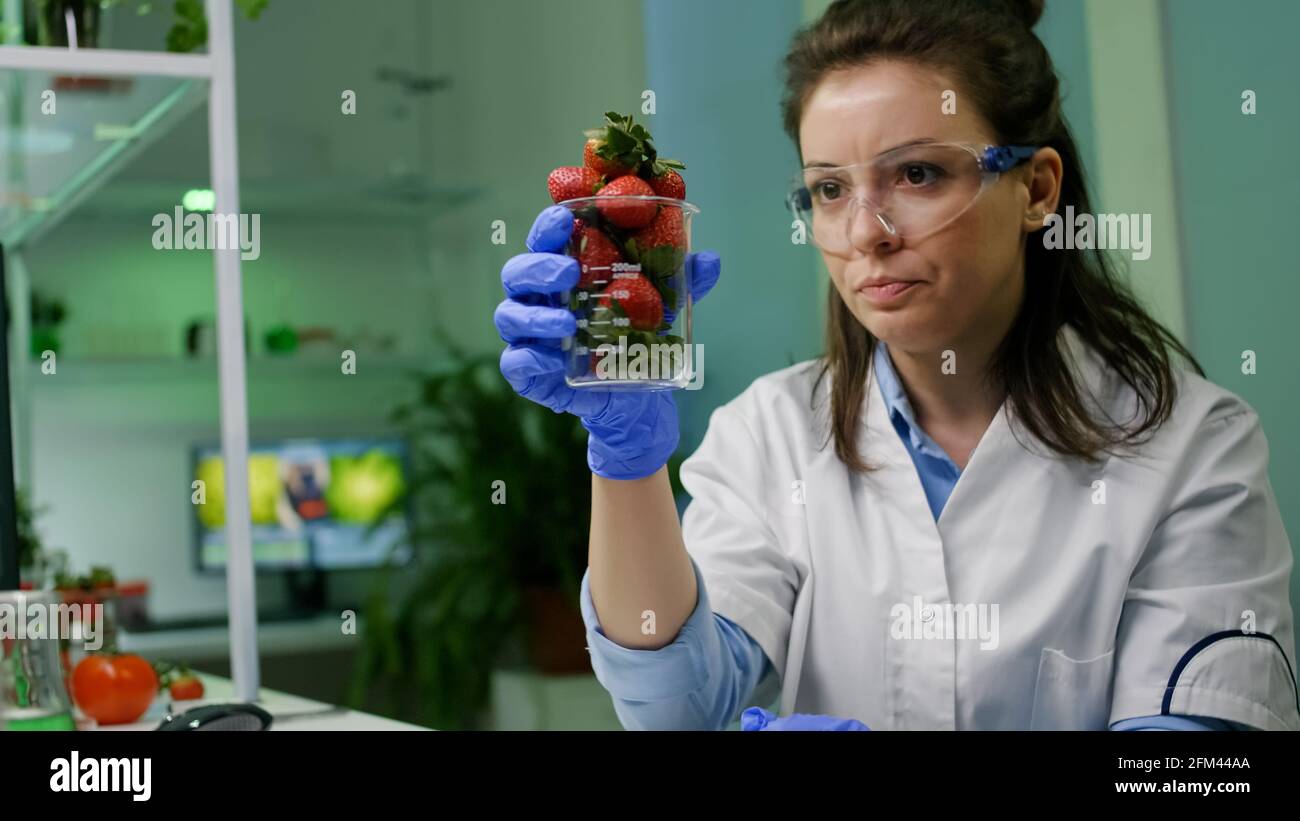 Chemist typing medical botany expertise on computer for agriculture ...