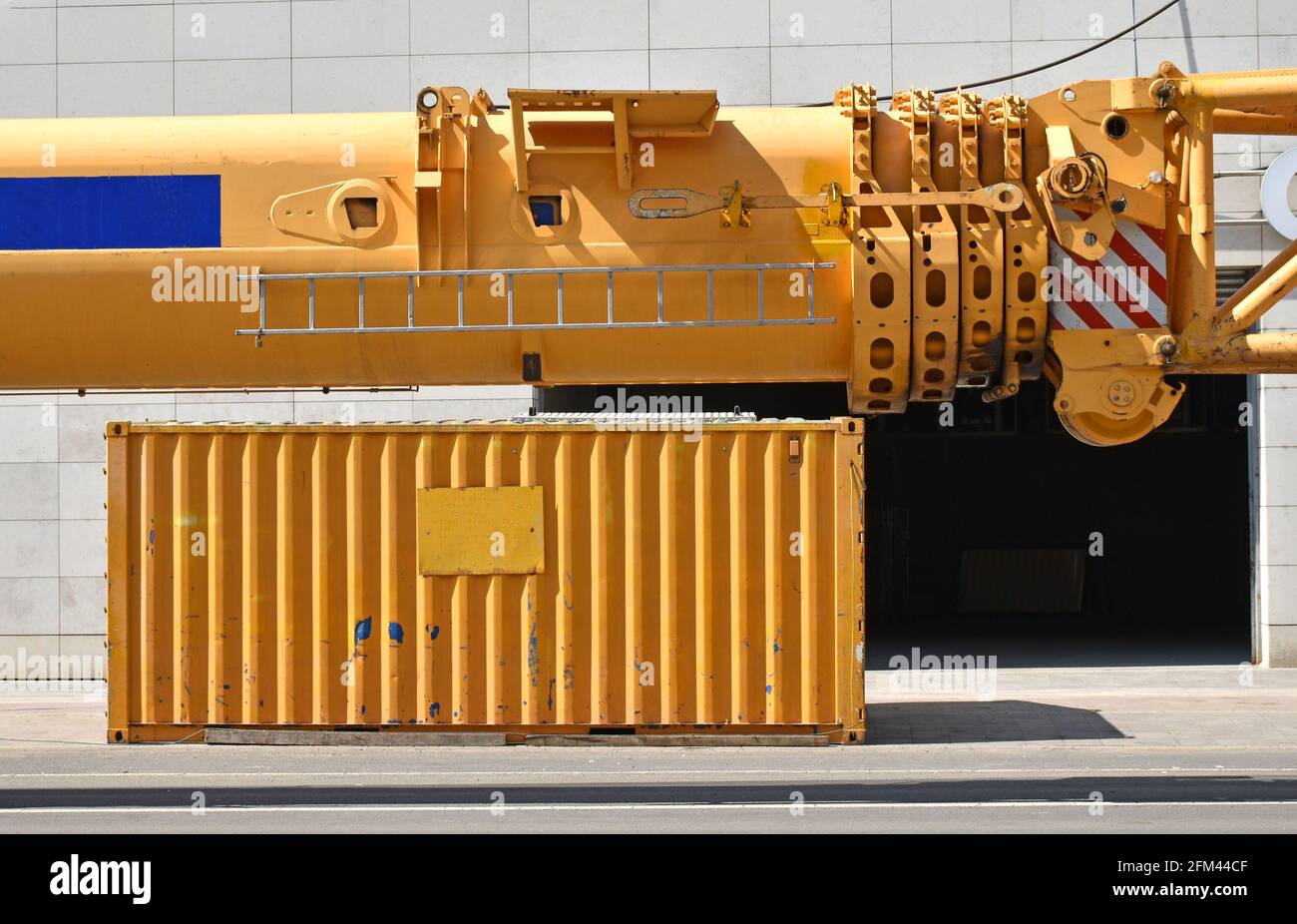 Part of a large mobile crane and a container Stock Photo - Alamy